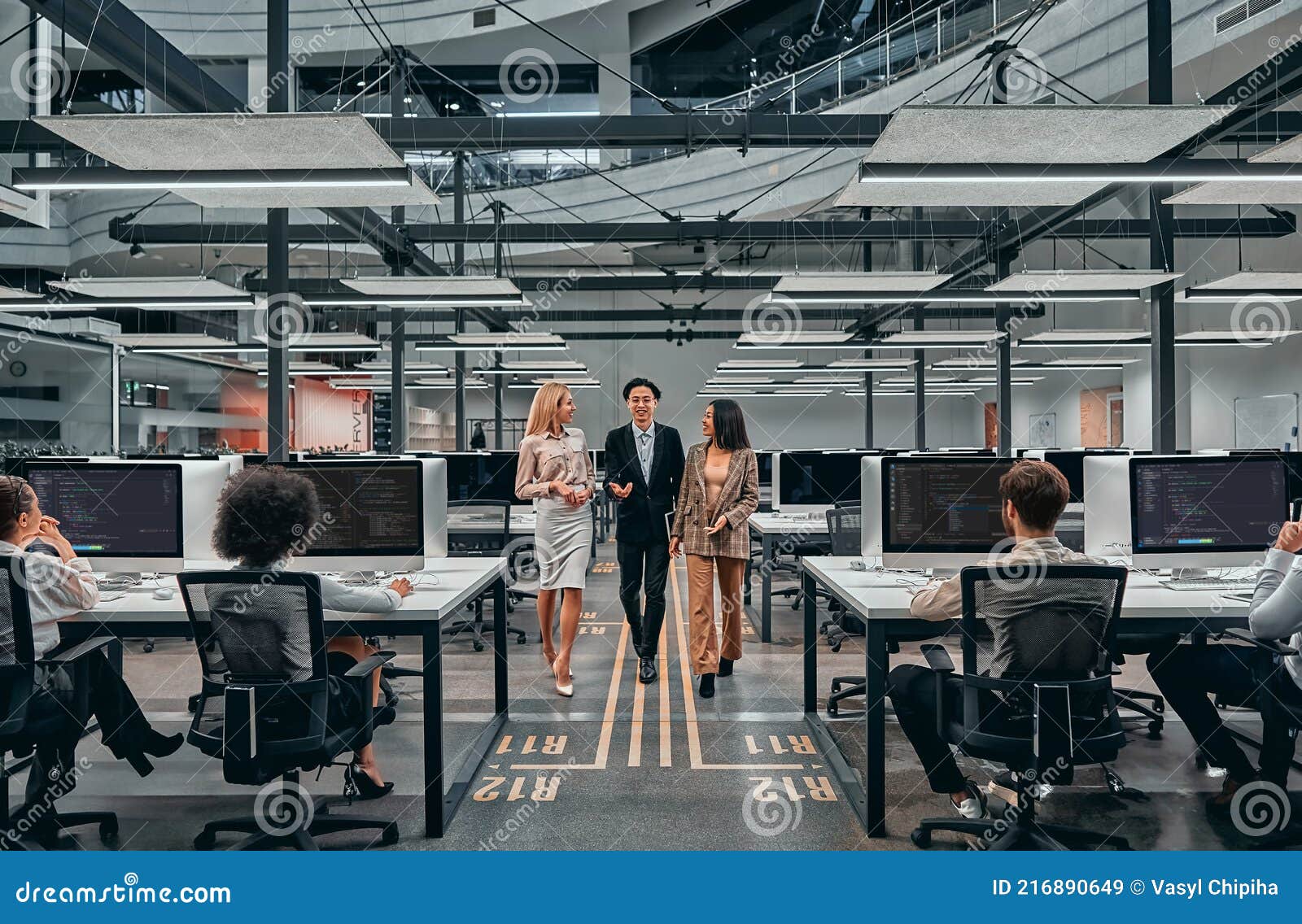 Three Business People Walk Around a Spacious Large Office with a Lot of ...