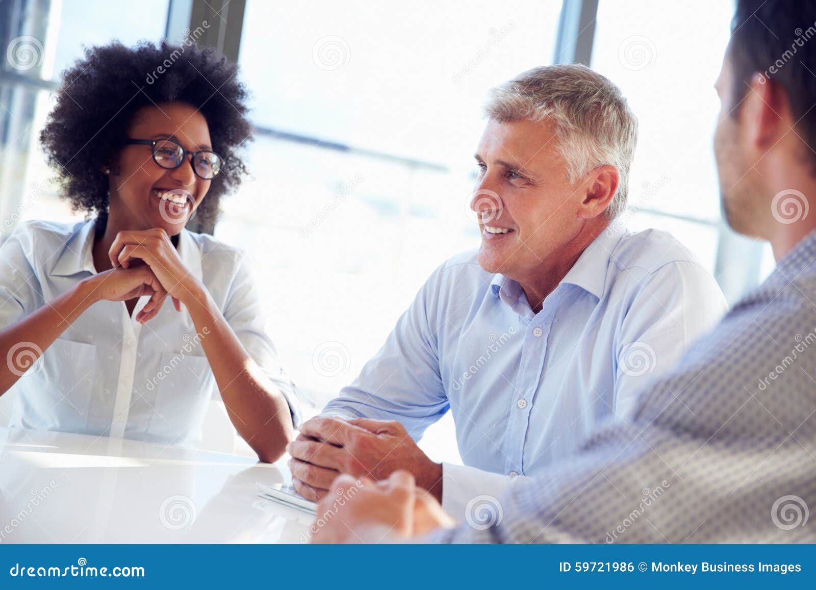 Three Business Professionals Working Together Stock Photo - Image of ...