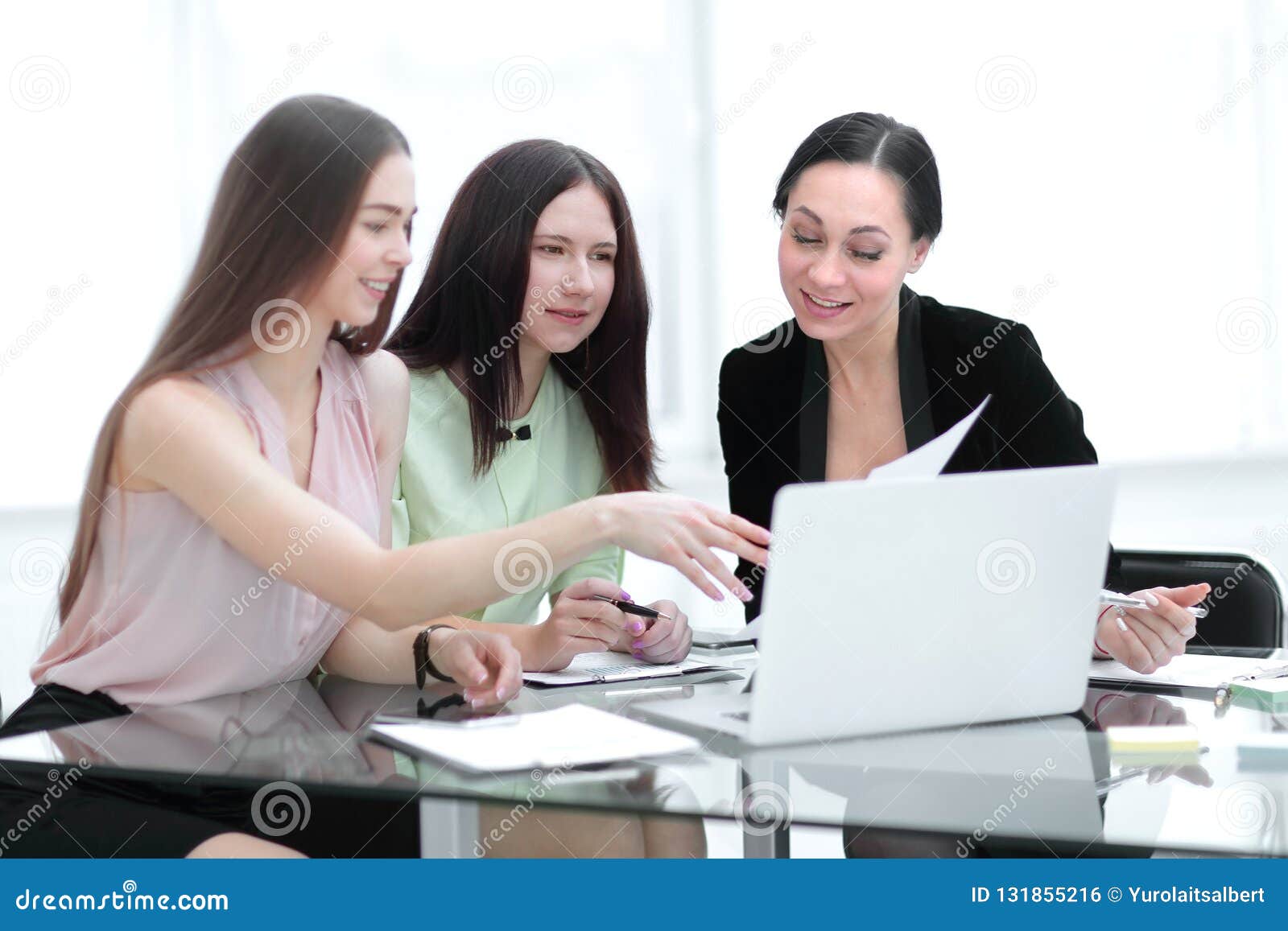 Three Business Women Discussing Work Issues in the Office Stock Photo ...