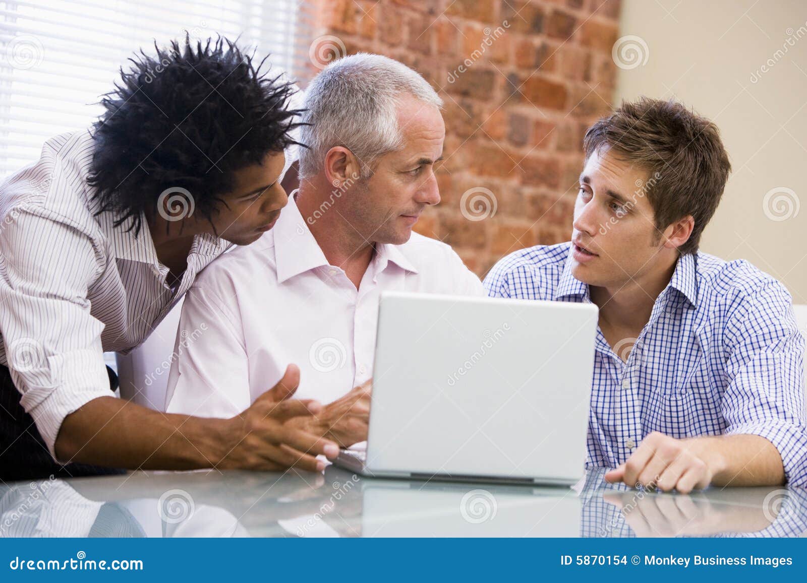 Three Businessmen in Office with Laptop Stock Photo - Image of ...