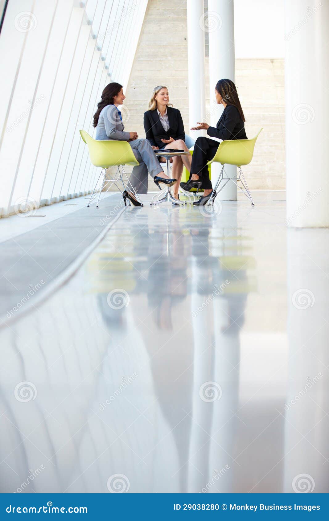 Three Businesswomen Meeting Around Table in Modern Office Stock Photo ...