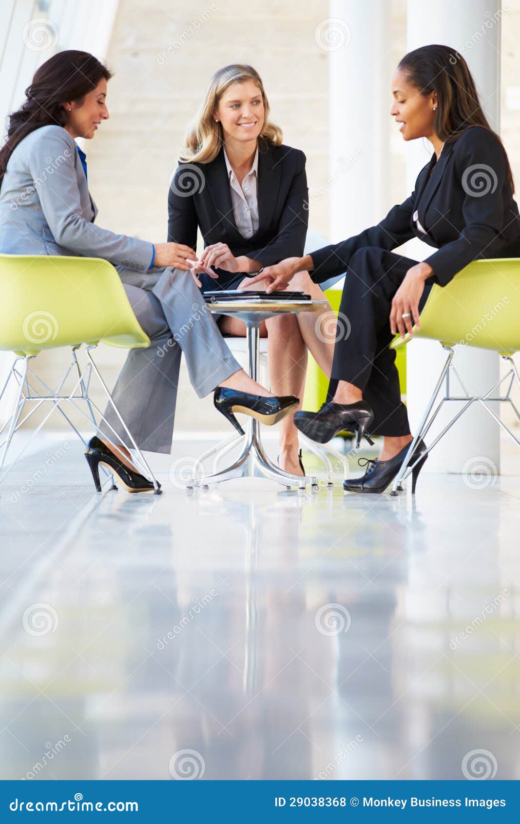 Three Businesswomen Meeting Around Table in Modern Office Stock Photo ...