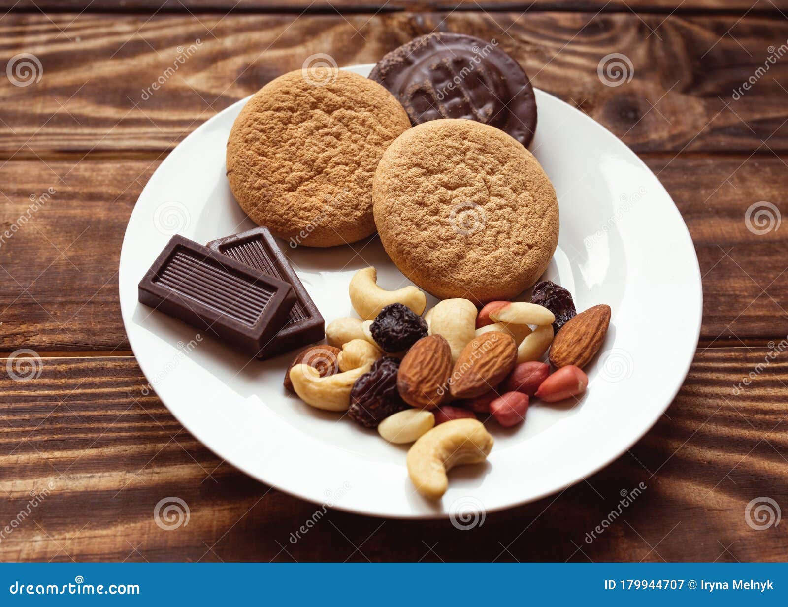 Three Cakes, Variety of Nuts and Two Chocolate on the White Plate on ...