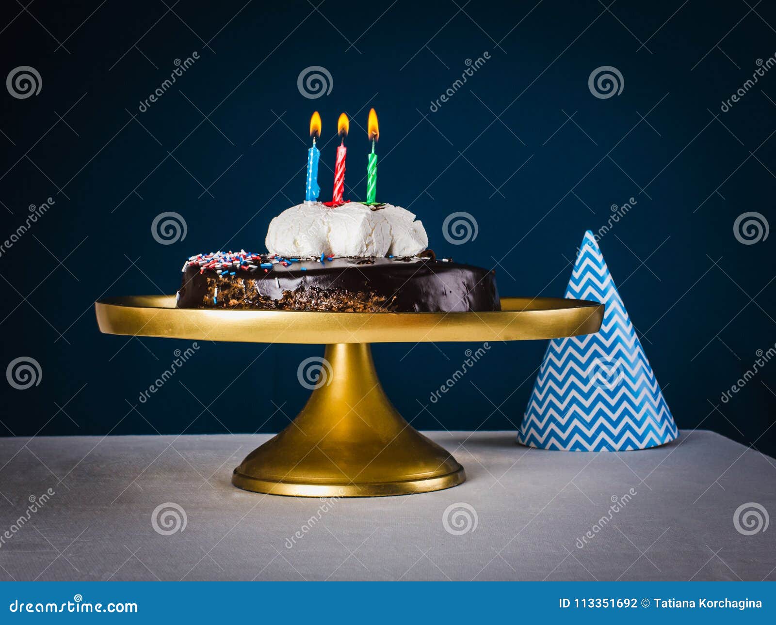 Three Candles in Chocolate Cake on Golden Tray and Dark Blue Ba Stock ...