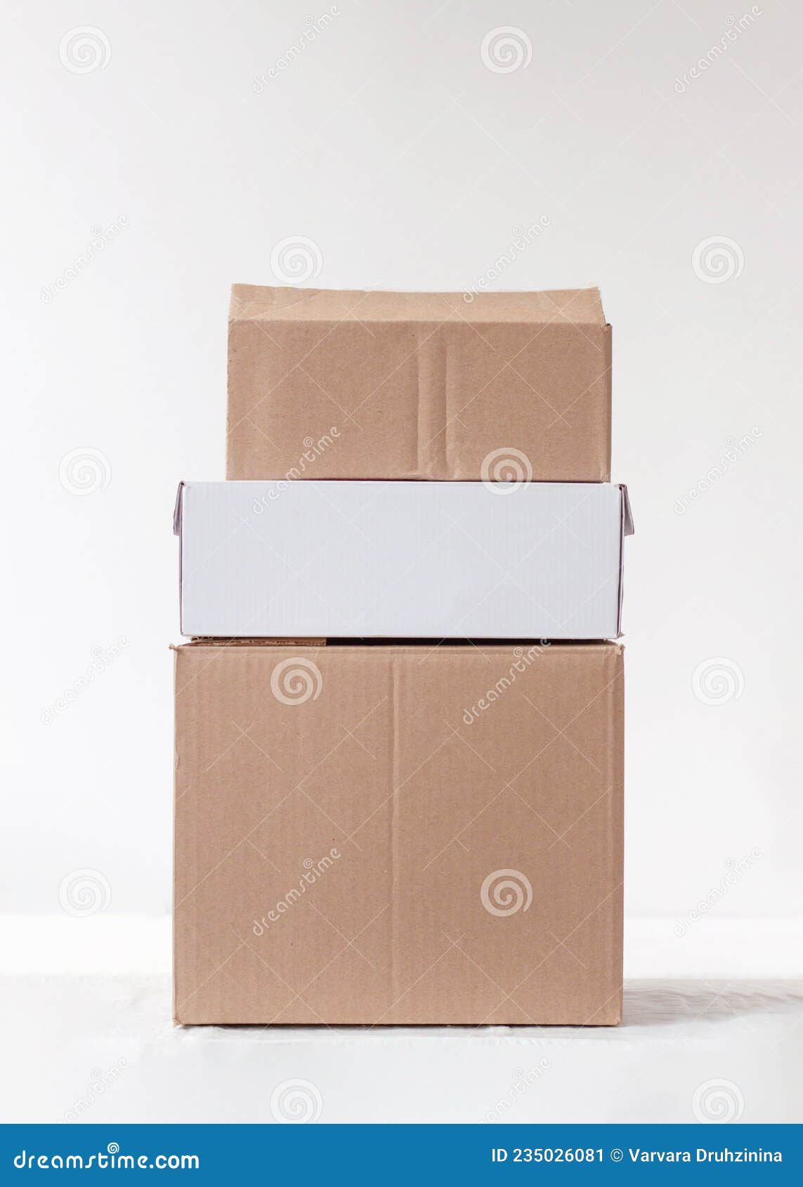 Three Cardboard Boxes are Stacked on Top of Each Other on a White ...