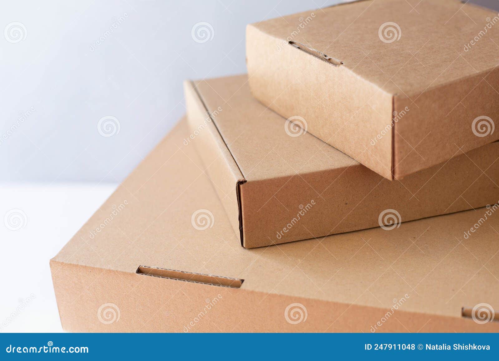 Three Packing Boxes Stand Stacked on Top of Each Other on a Gray ...