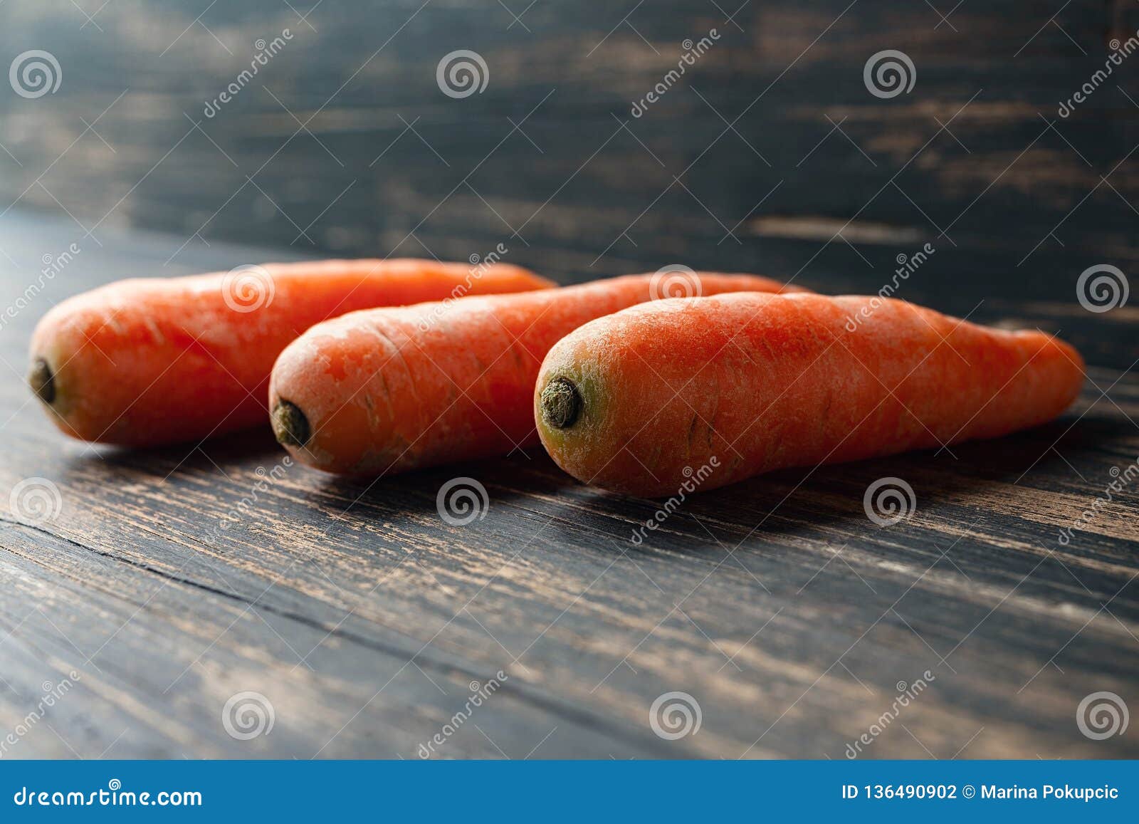 Three Carrots on a Dark Rustic Wooden Background Stock Photo - Image of ...