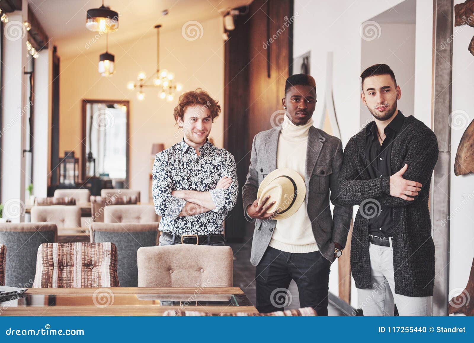 Three Cheerful Young Men Standing and Smiling Together Stock Photo ...