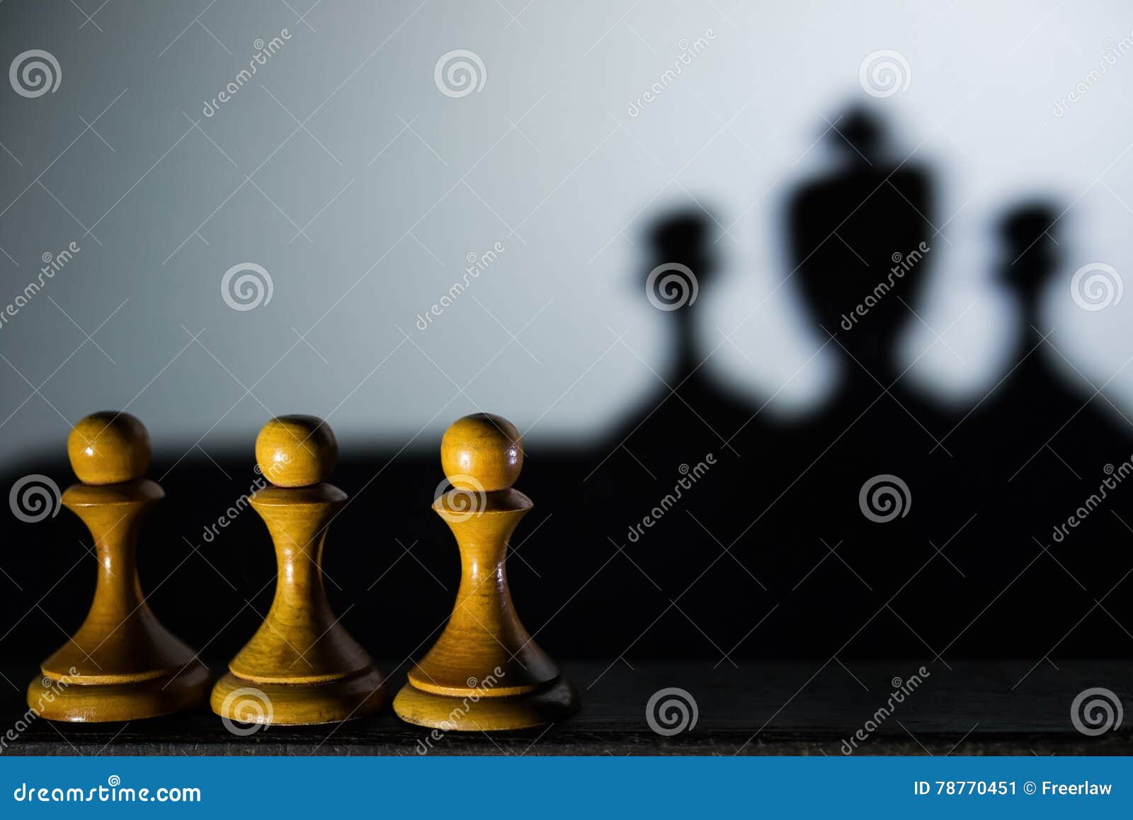 Three Chess Pawn with One Casting a King Piece Shadow in Dark Concept ...