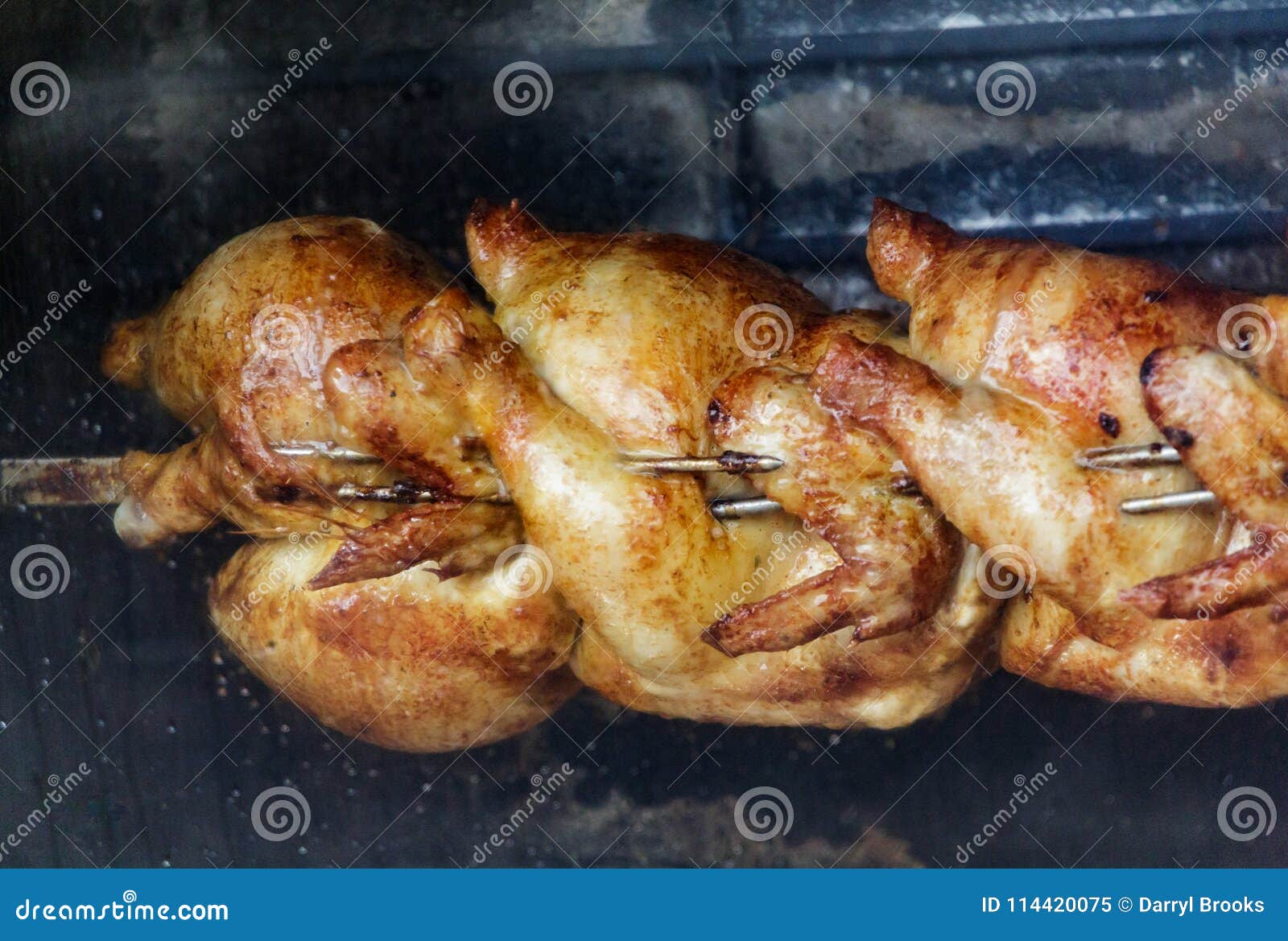 Chickens Roasting on Spit stock image. Image of meat - 114420075