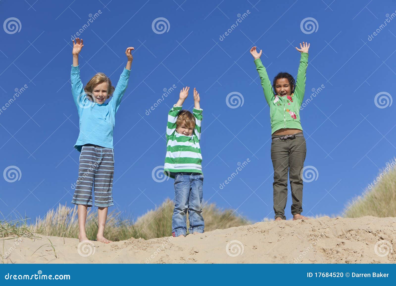Three Children Arms Raised Having Fun on Beach Stock Photo - Image of ...