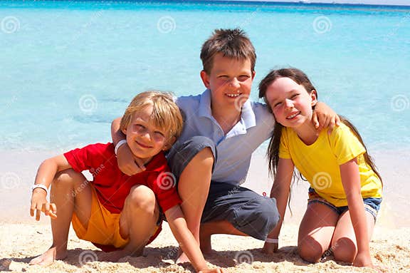 Three children on beach stock photo. Image of children - 2626296
