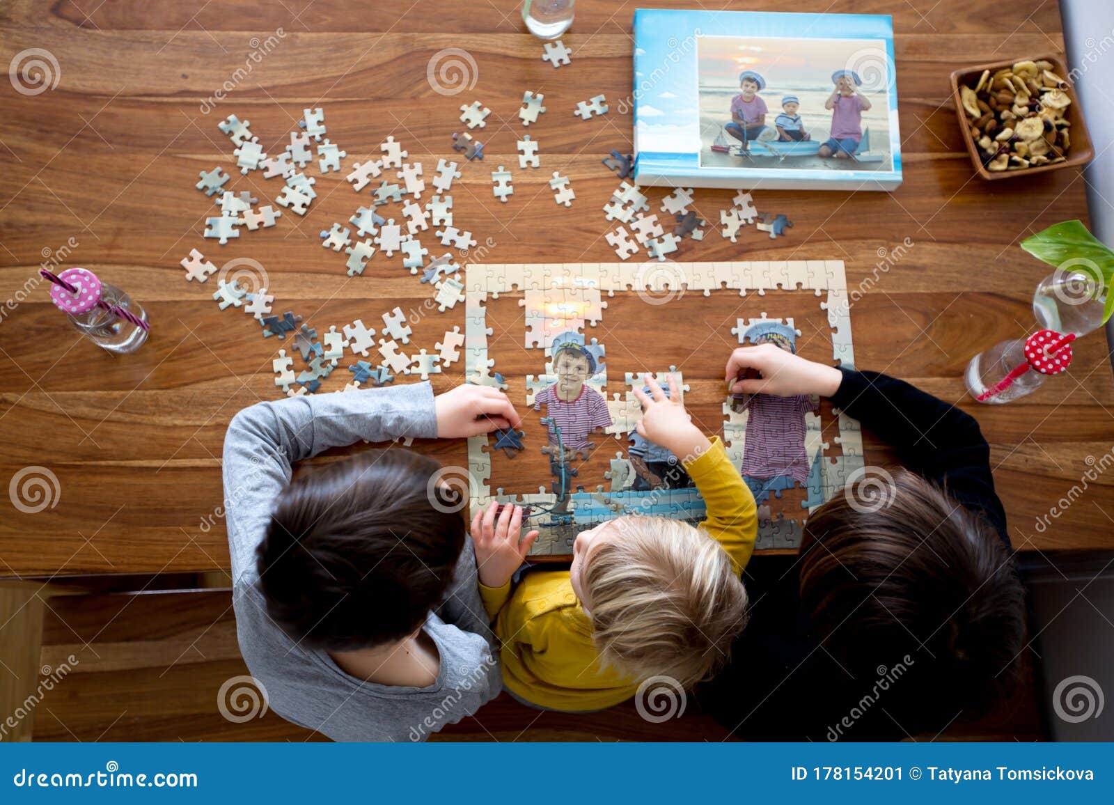 Three Children, Boys, Assembling Puzzle with Their Picture from the ...