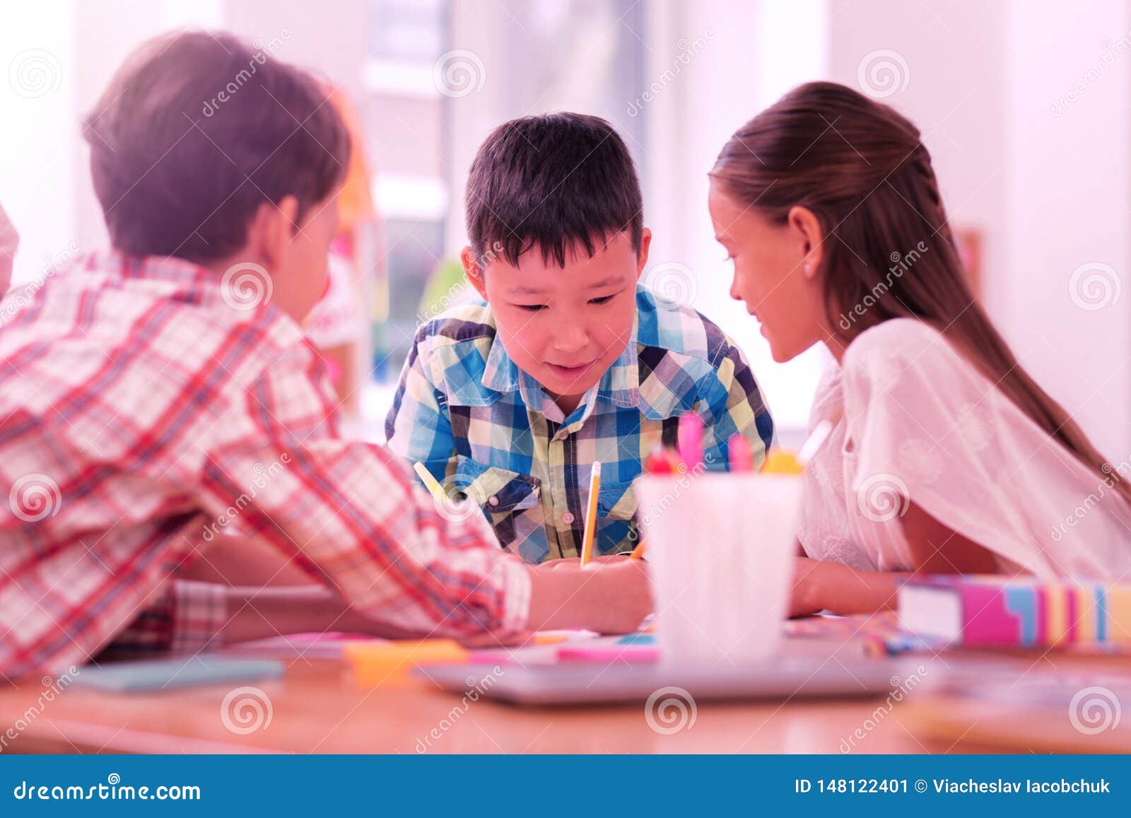 Three Children Drawing a School Project Together. Stock Image - Image ...