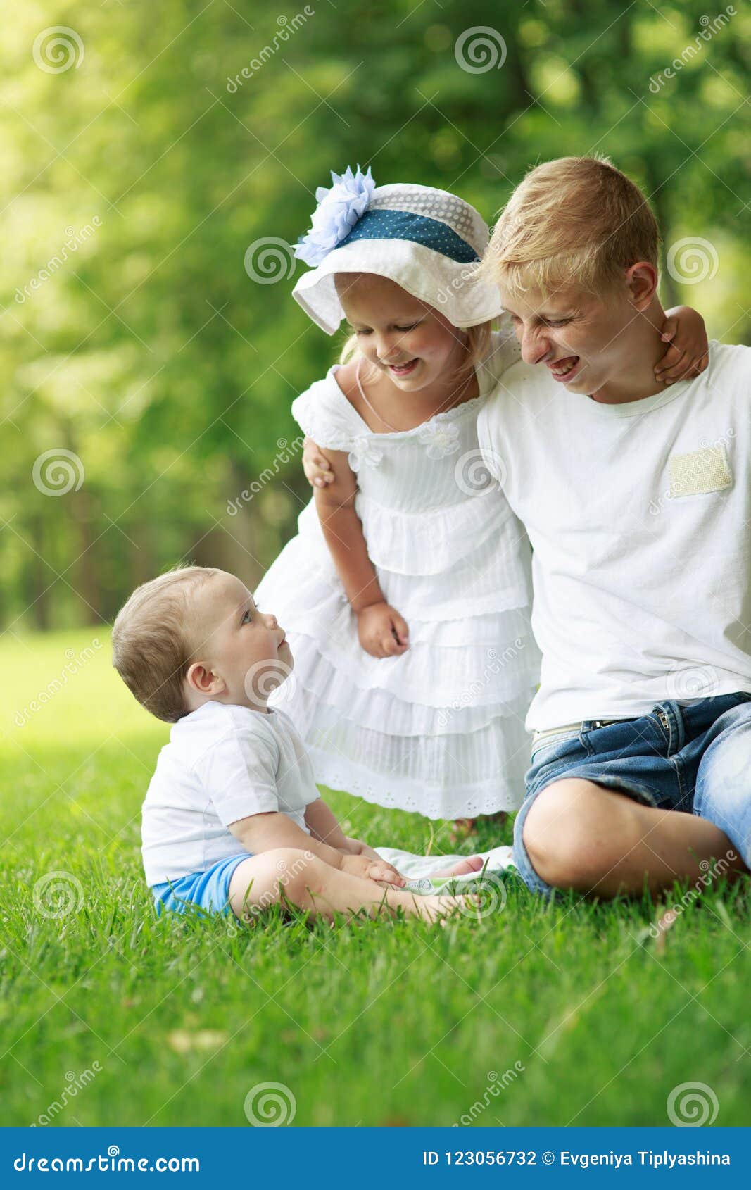 Three Children on the Grass Stock Photo - Image of childhood, sitting ...