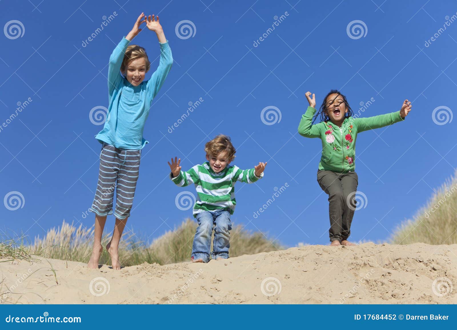 Three Children Jumping Having Fun on Beach Stock Photo - Image of mixed ...