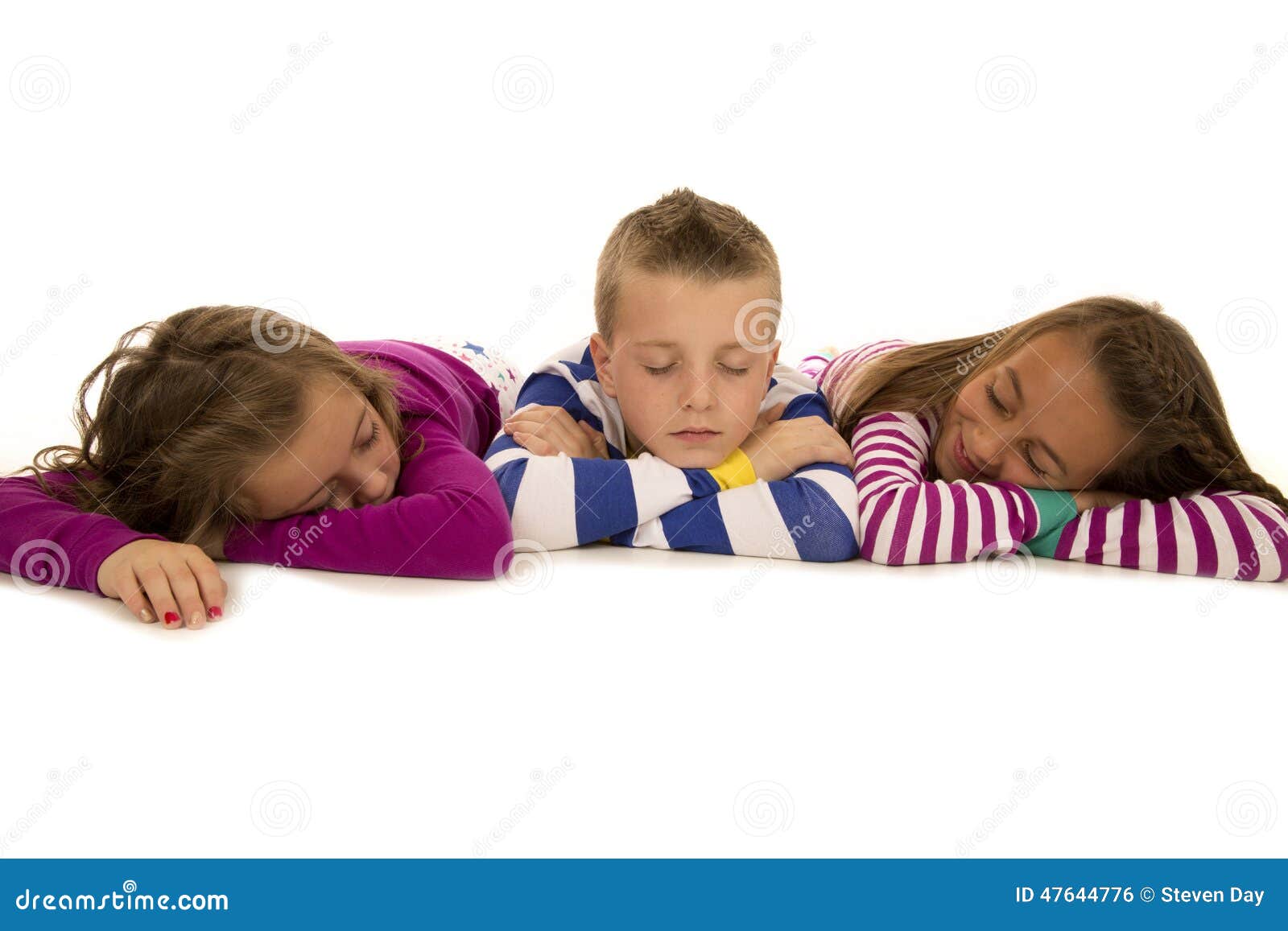 Three Children Laying Down in Pajamas Faking Sleep Stock Photo - Image ...