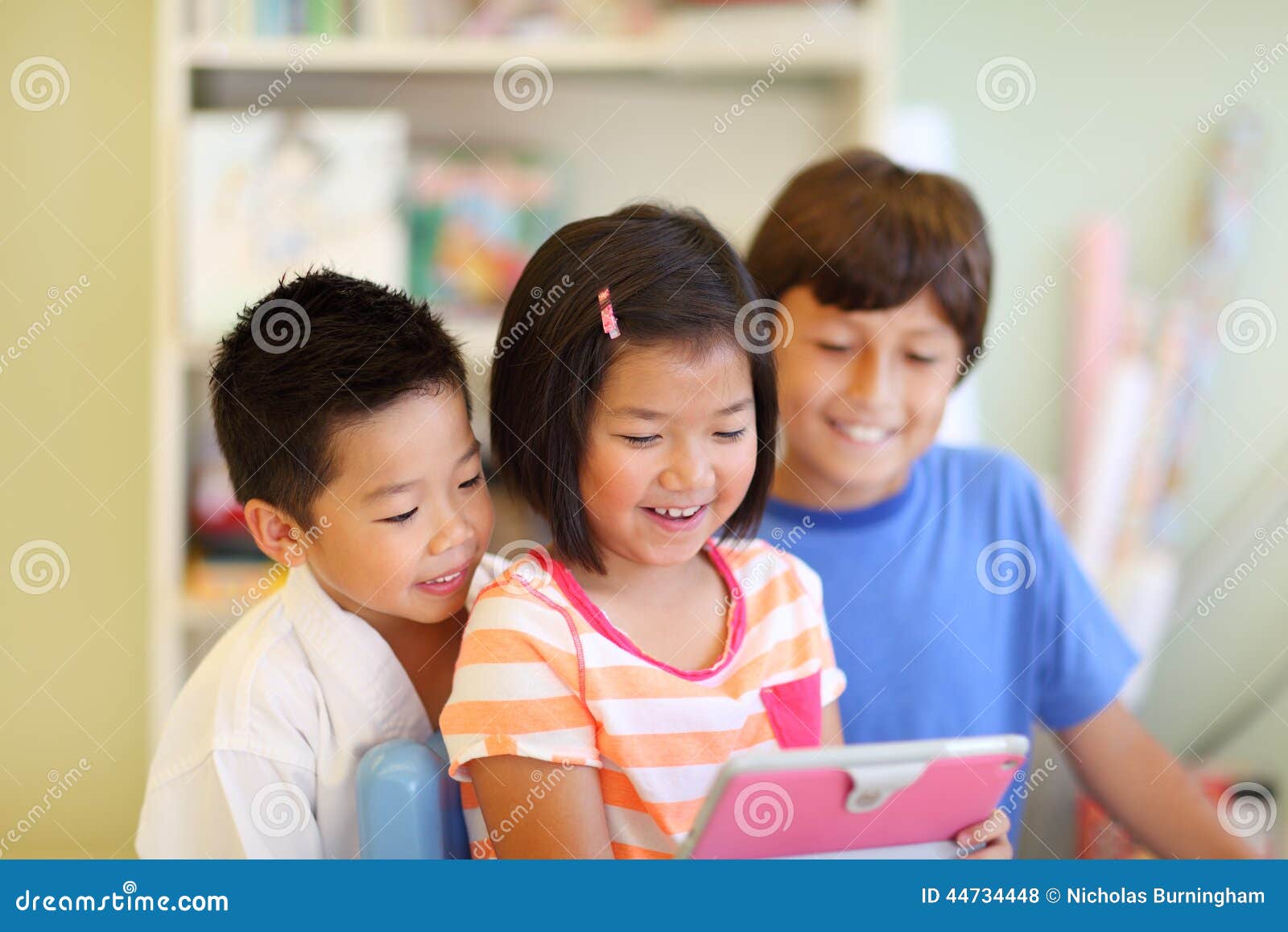 Three Children Look at a Tablet Computer Stock Photo - Image of look ...