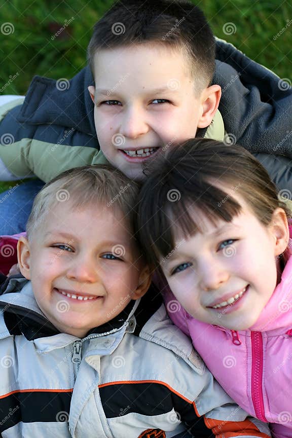 Three Children in the Meadow Stock Image - Image of casual, children ...
