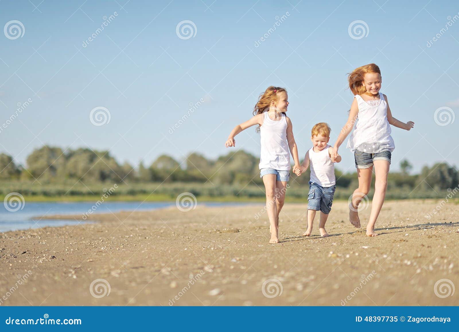 Three Children Playing on Beach Stock Image - Image of smiling, family ...