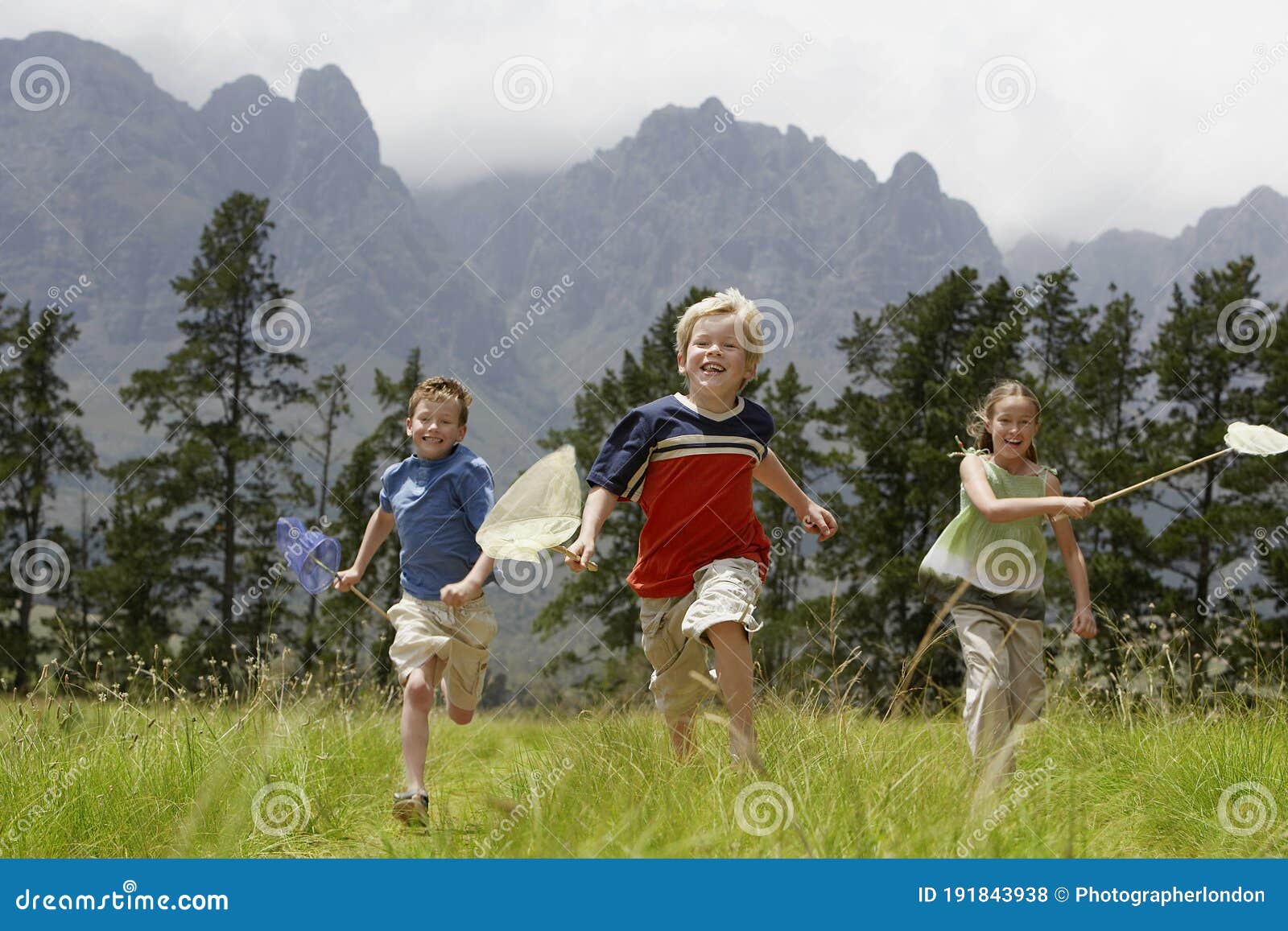 Three Children 7-9 Running through Field with Butterfly Nets. Stock ...