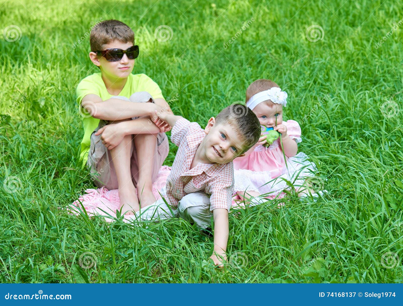 Three Children Sit in Grass, Playing and Having Fun. Stock Image ...