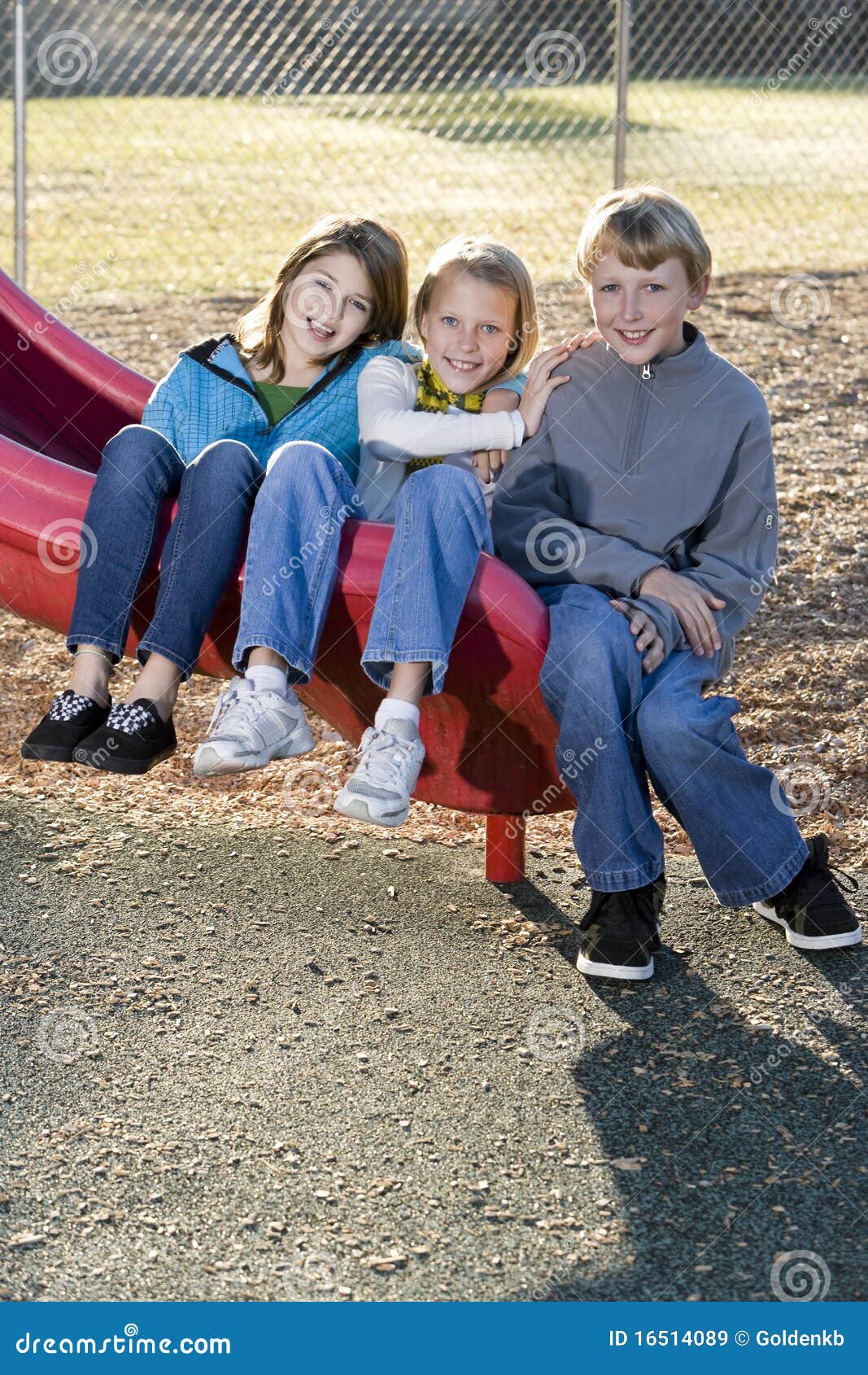 Three Children Sitting on Slide Stock Image - Image of cheerful ...