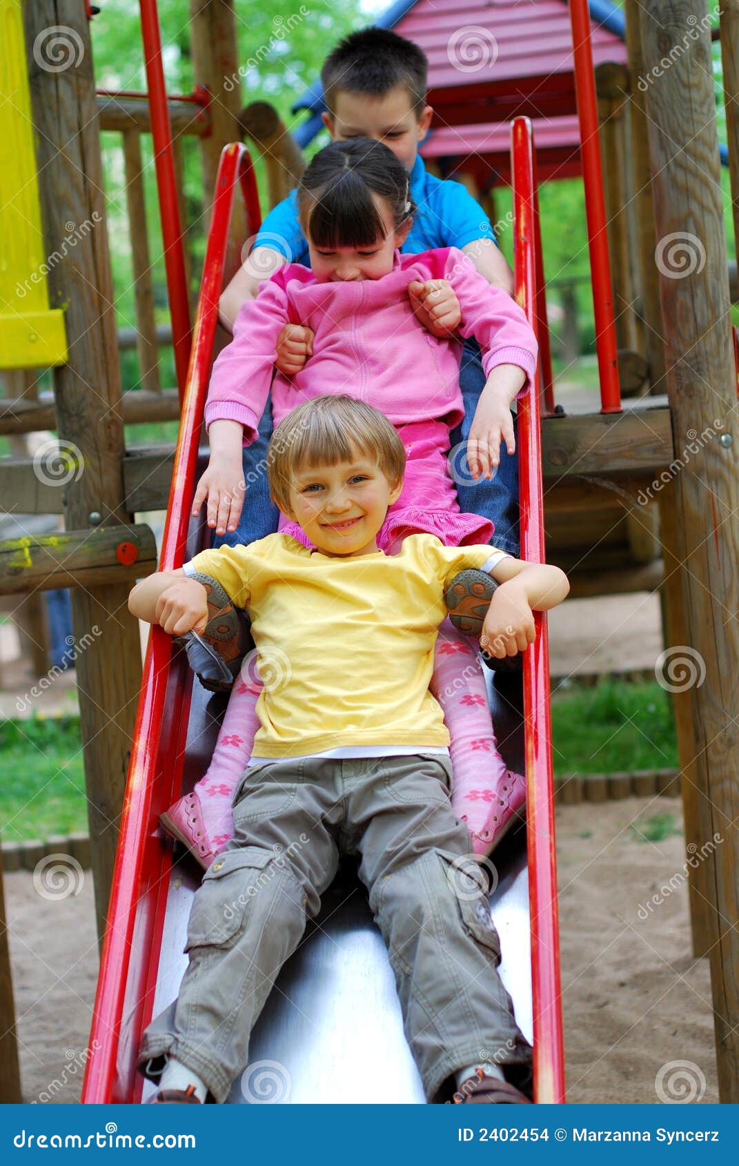 Three Children on Slide stock photo. Image of child, grinning - 2402454