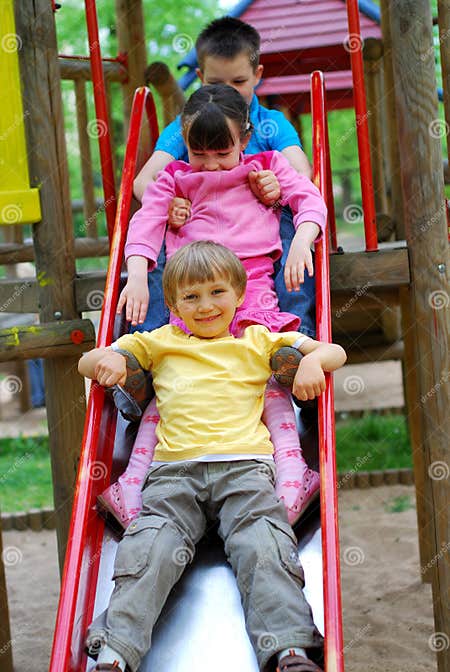 Three Children on Slide stock photo. Image of child, grinning - 2402454