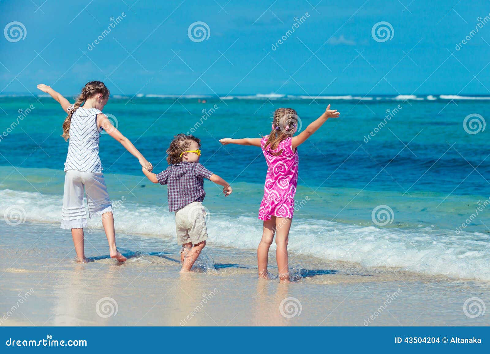 Three Children Standing on the Beach Stock Photo - Image of girl ...