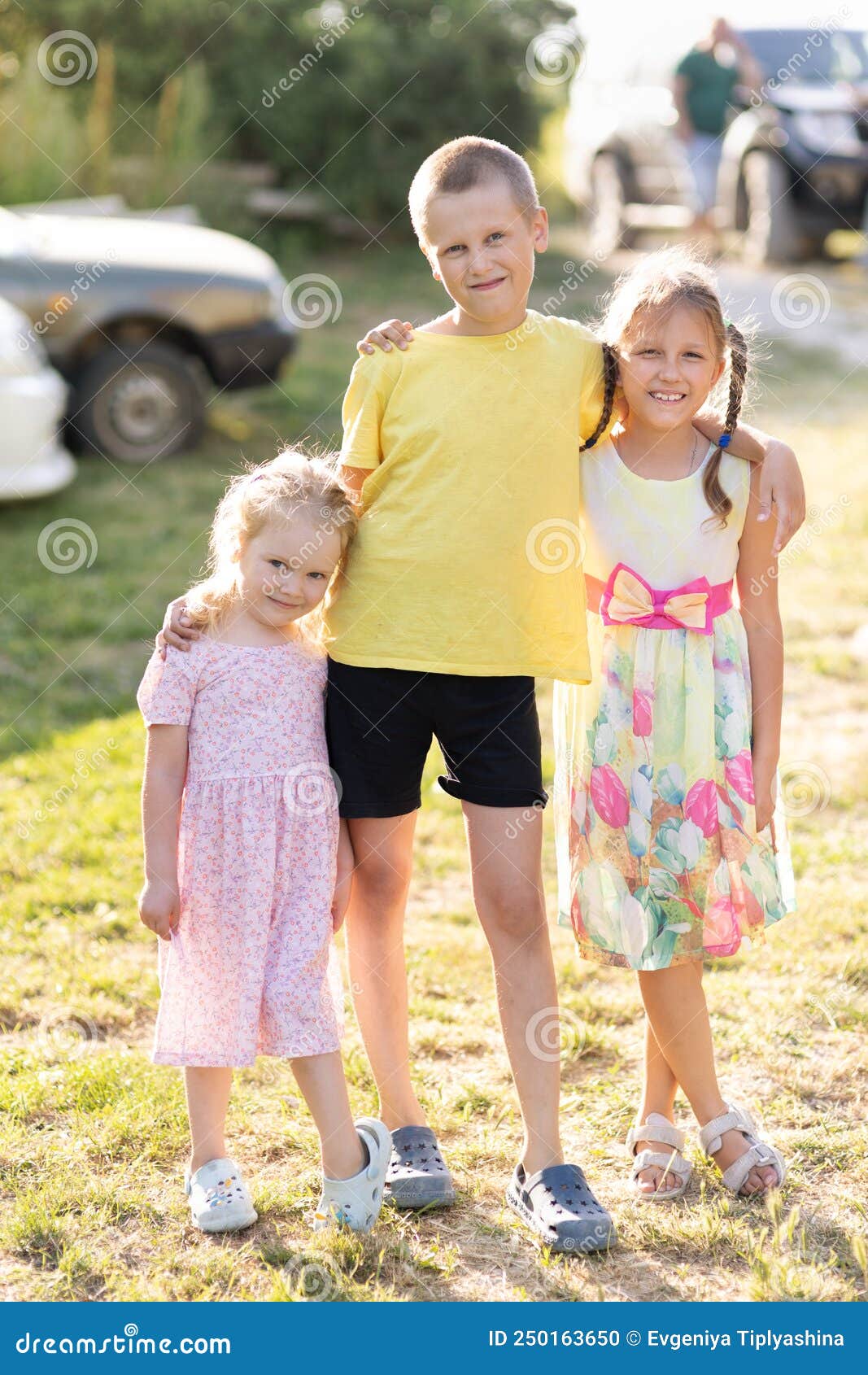 Three children in the yard stock photo. Image of little - 250163650