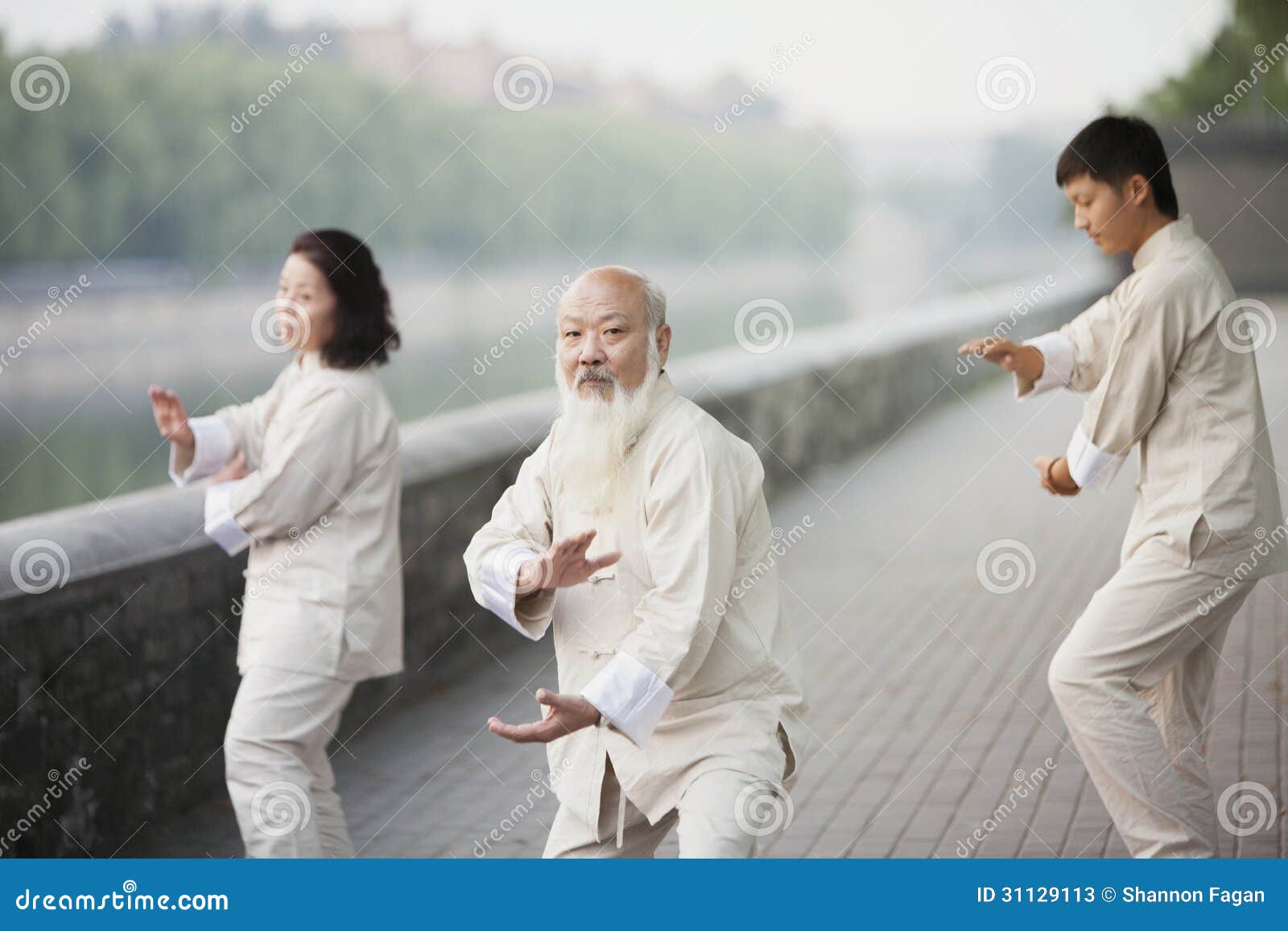 Three Chinese People Practicing Tai Ji Outdoors Stock Image - Image of ...