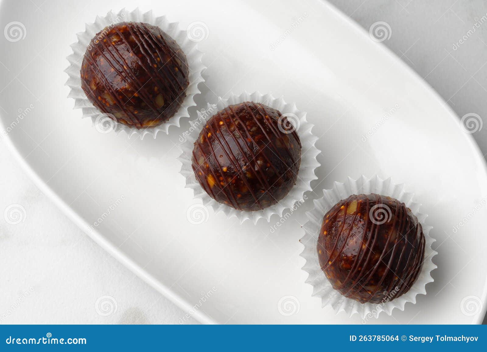 Three Chocolate Candies Sweets on White Plate Close Up Stock Photo ...
