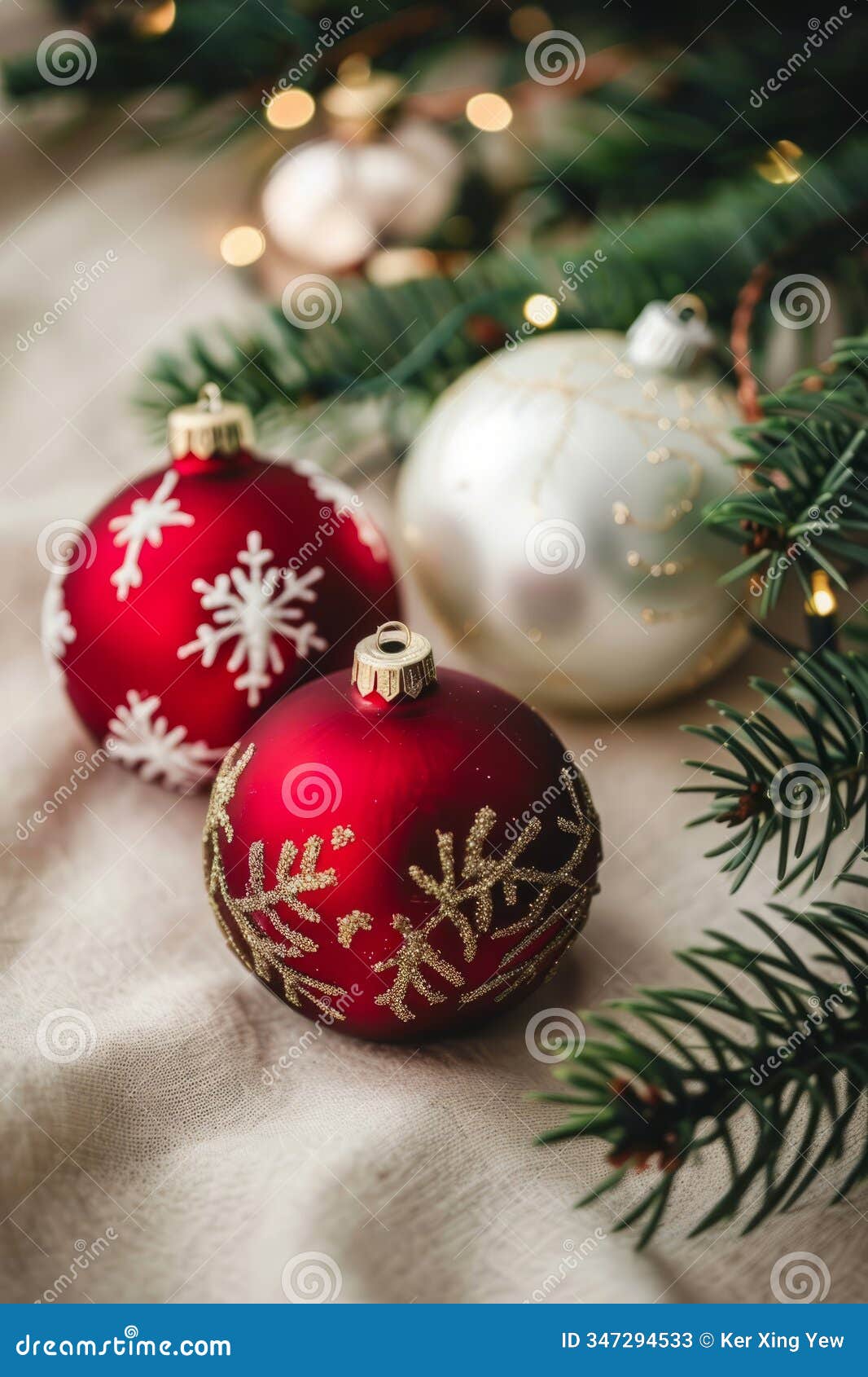Three Christmas Ornaments, Two Red and One White, are Hanging from a ...