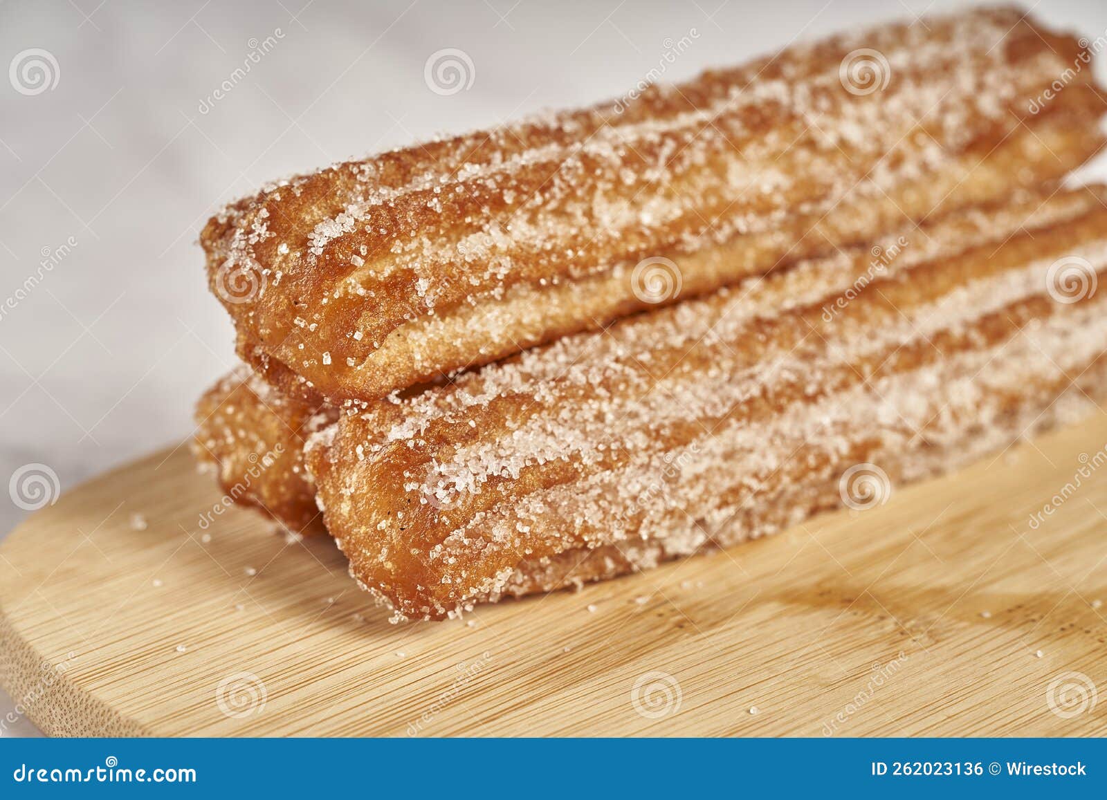 Close Up Shot of Three Churros with Sugar on a Wooden Board Stock Photo ...