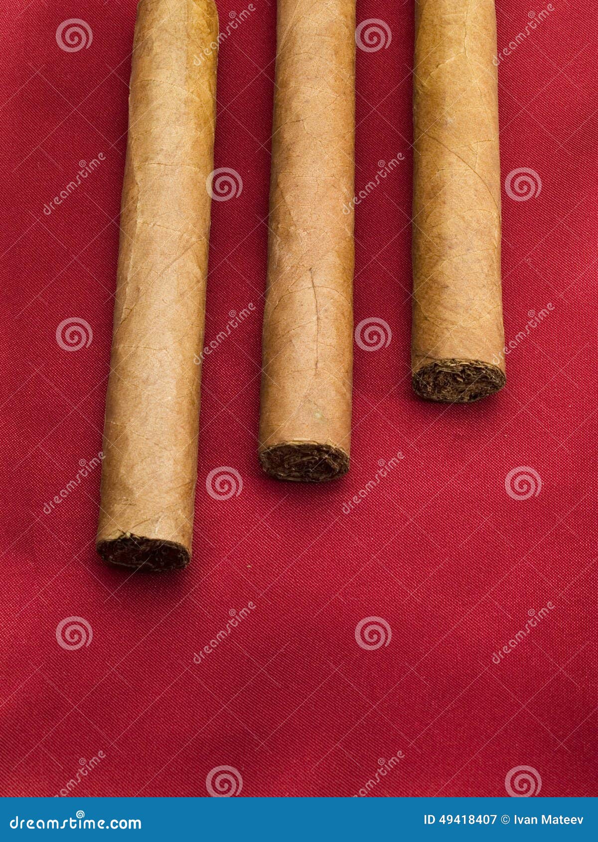 Three Cigars on red satin stock image. Image of culture - 49418407