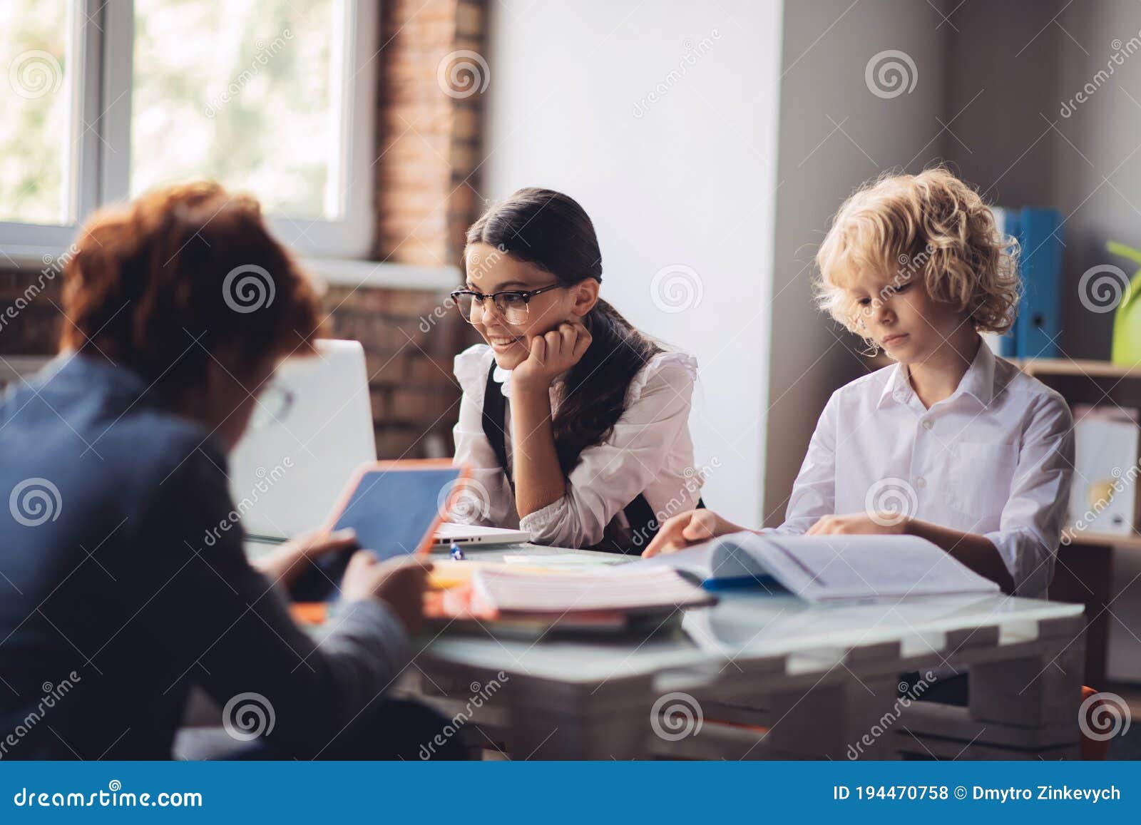 Three Classmates Sitting in the Classroom and Studying Stock Photo ...