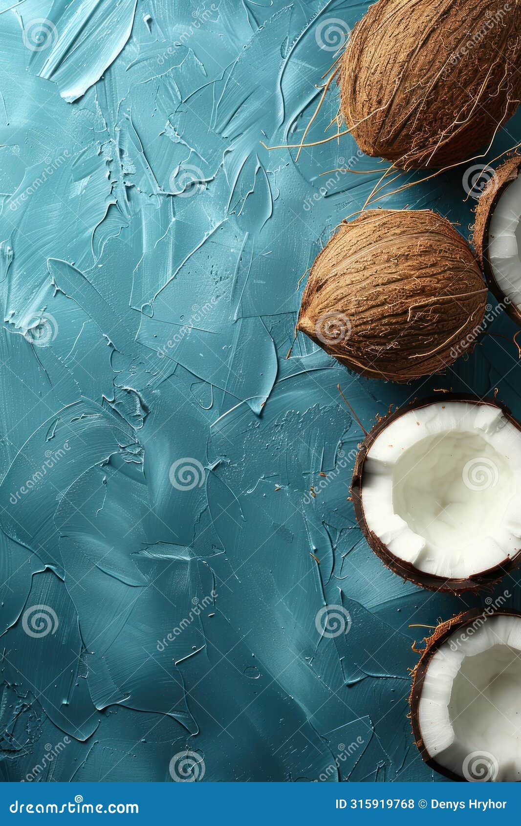 Three Coconuts Placed on a Blue Surface, with One Coconut Cut in Half ...