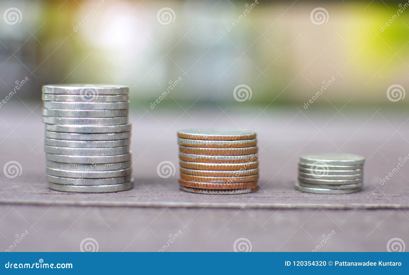 Three Coins Stack on the Wooden Table with Bokeh Garden Blurred ...
