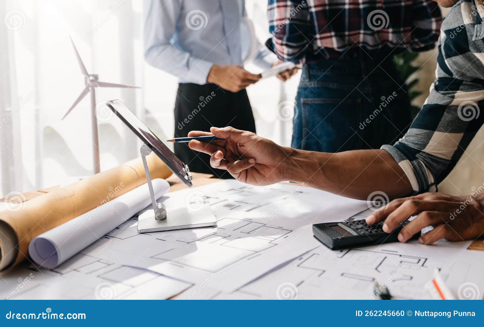 Three Colleagues Discussing Data Working and Tablet, Laptop with on on ...