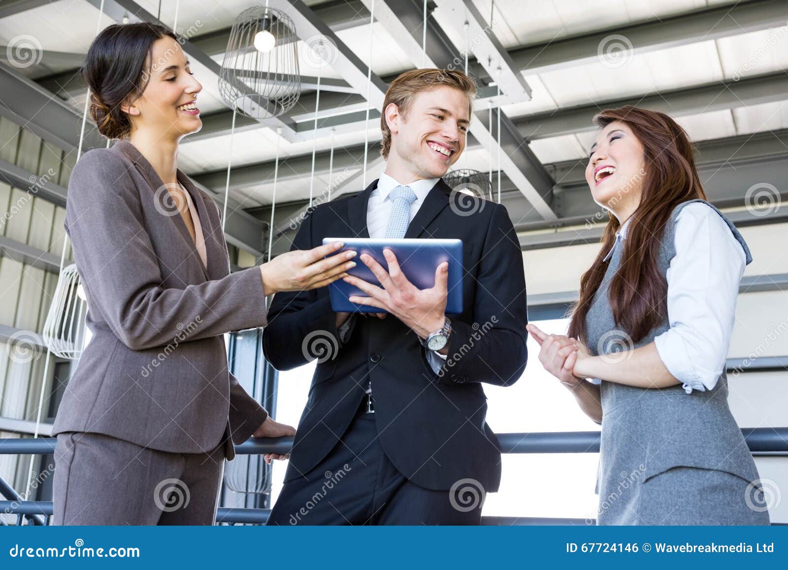 Three Colleagues Discussing in Office Stock Photo - Image of business ...