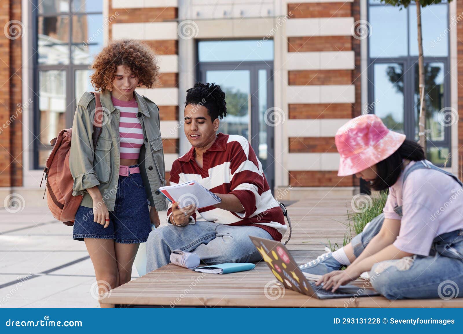 Three College Students Doing Homework Together Outdoors Stock Photo ...