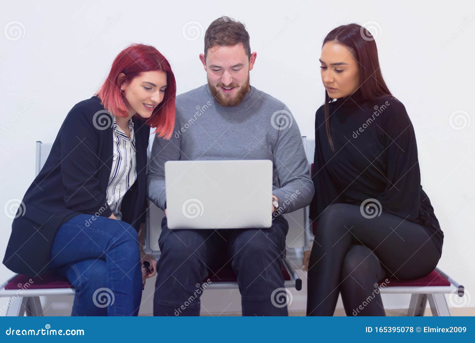 Three College Students Sitting and Using Laptop and Chatting after ...