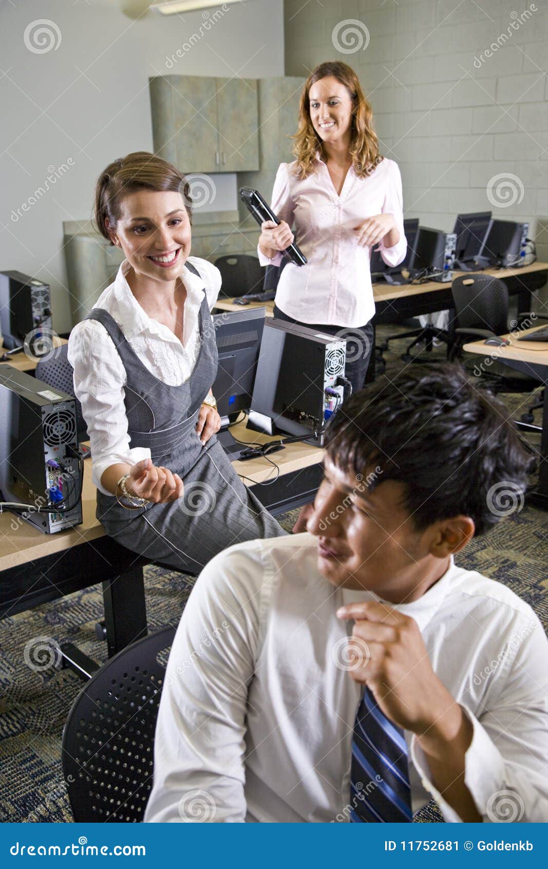 Three College Students Talking in Computer Lab Stock Image - Image of ...