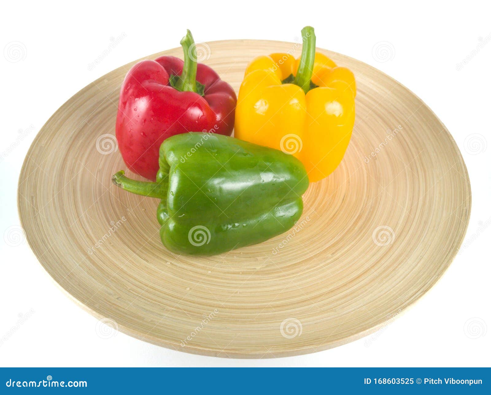Three Colored Bell Pepper on a Wooden Plate Stock Image - Image of ...