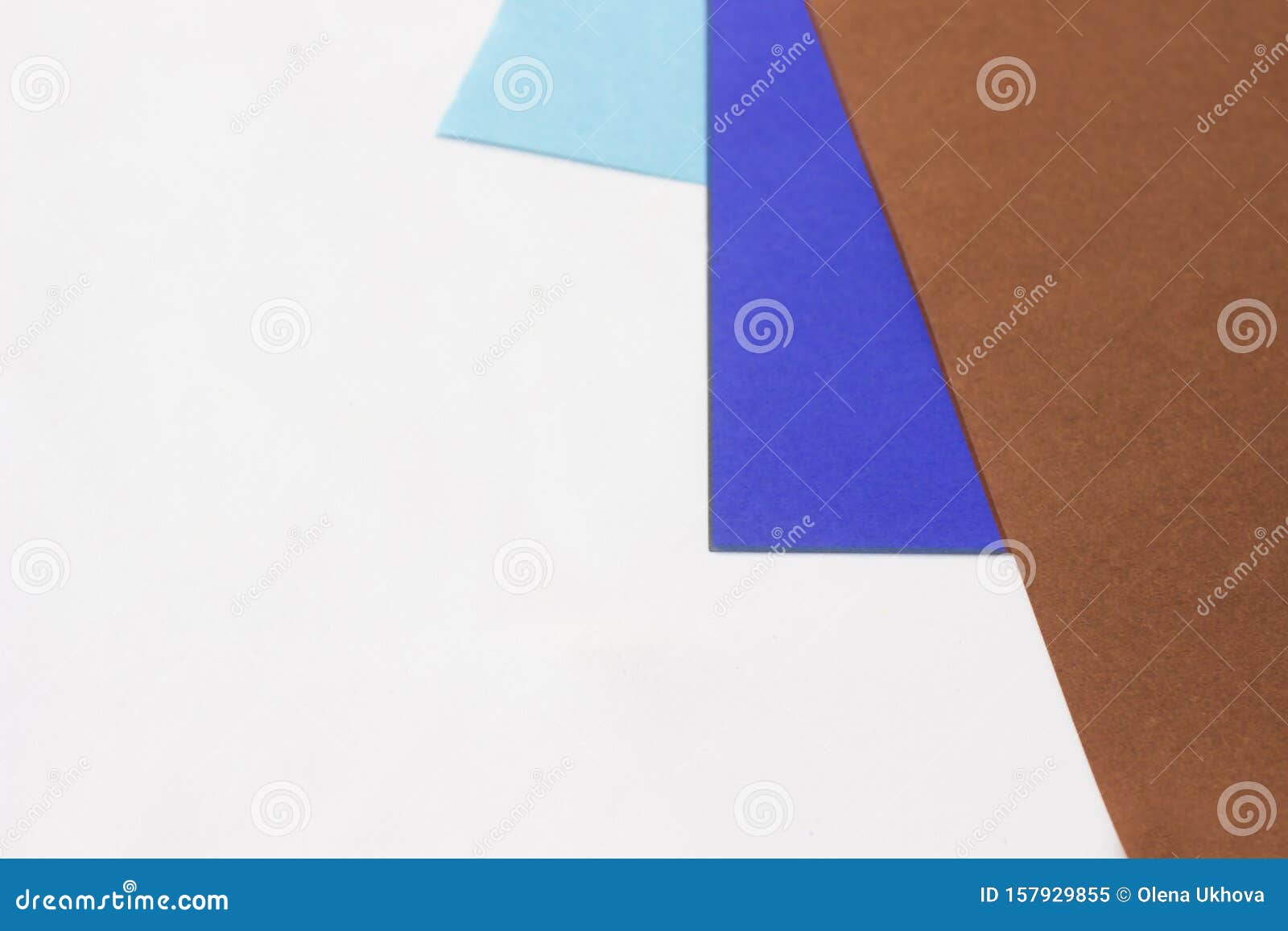 Three Colored Papers with Blue, Violet and Brown Colors on White in the ...