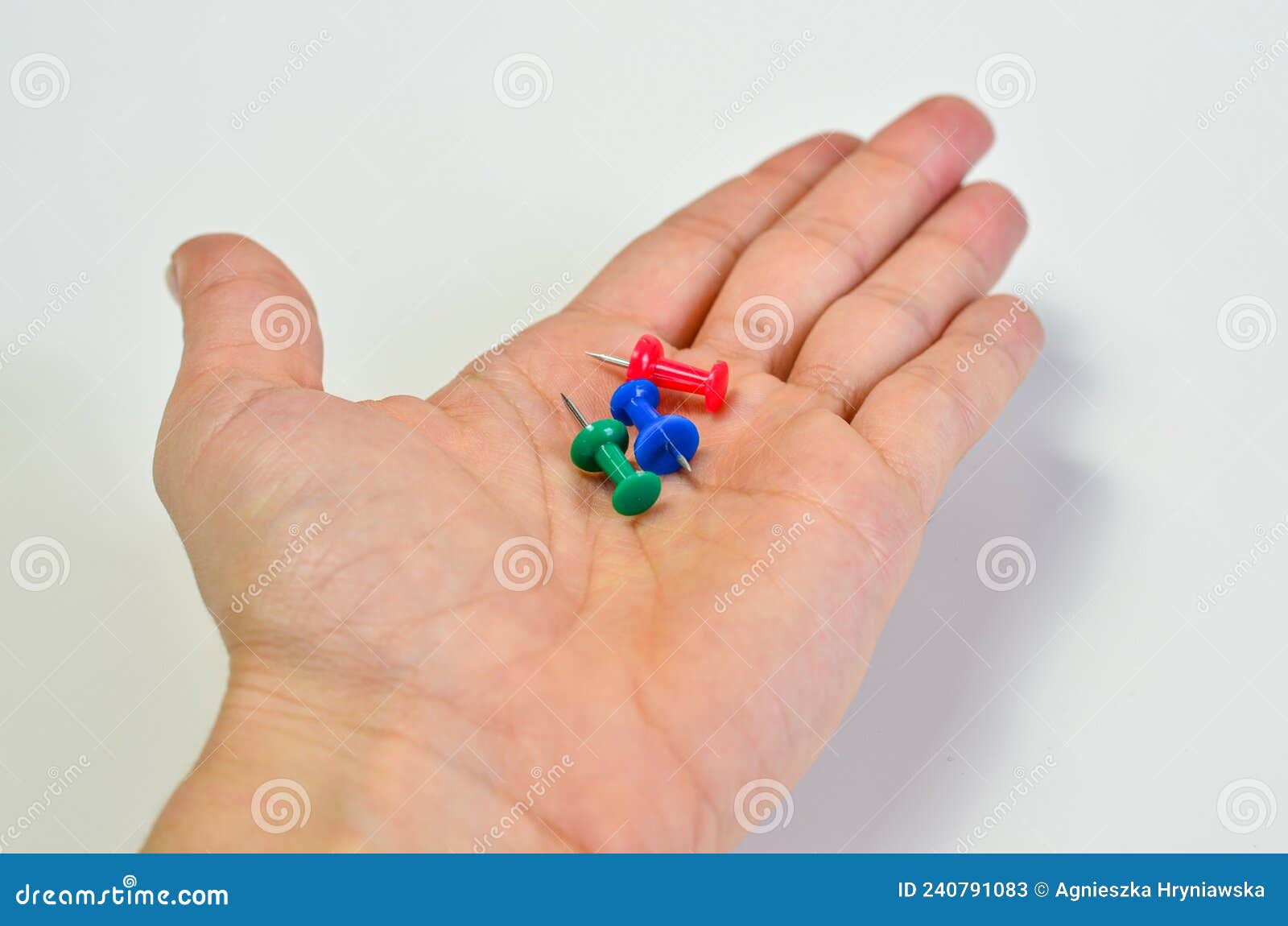 Three Colored Push Pins on a Hand Stock Image - Image of white, pushpin ...