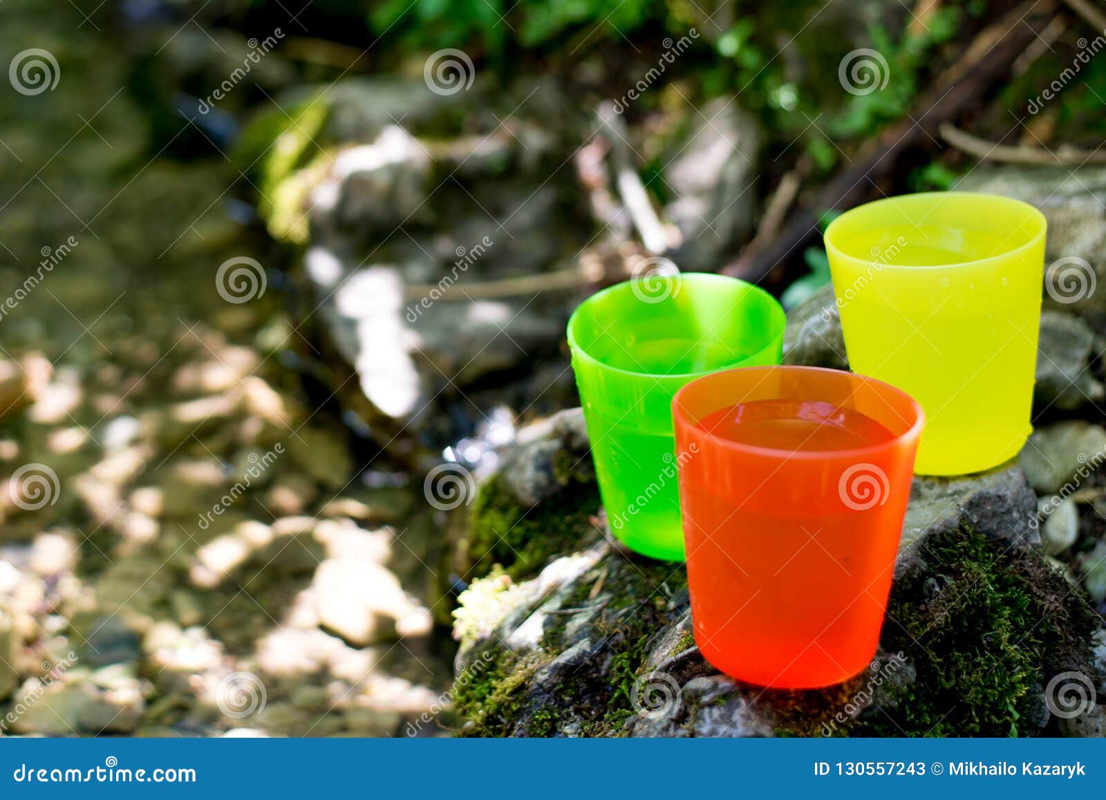 Three Colorful Cups Near the Spring with Water Stock Image - Image of ...