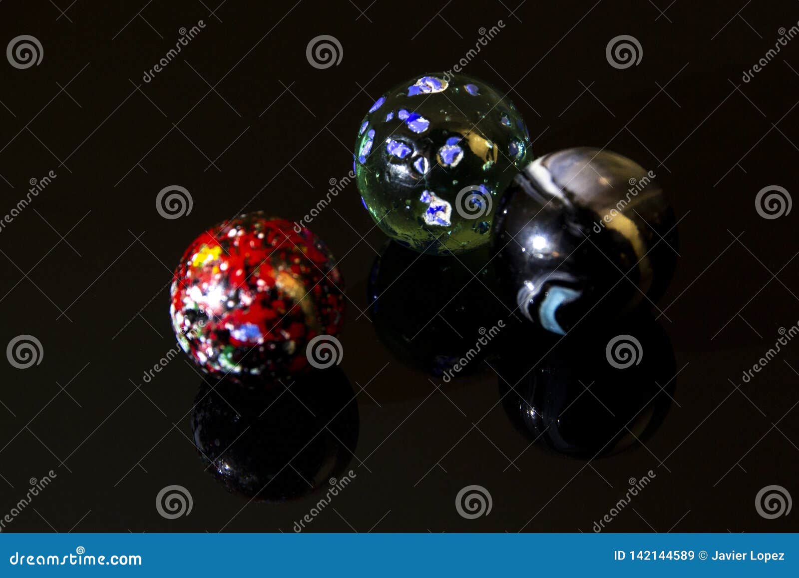 Three Colorful Marbles in a Closeup Photography Stock Image - Image of ...