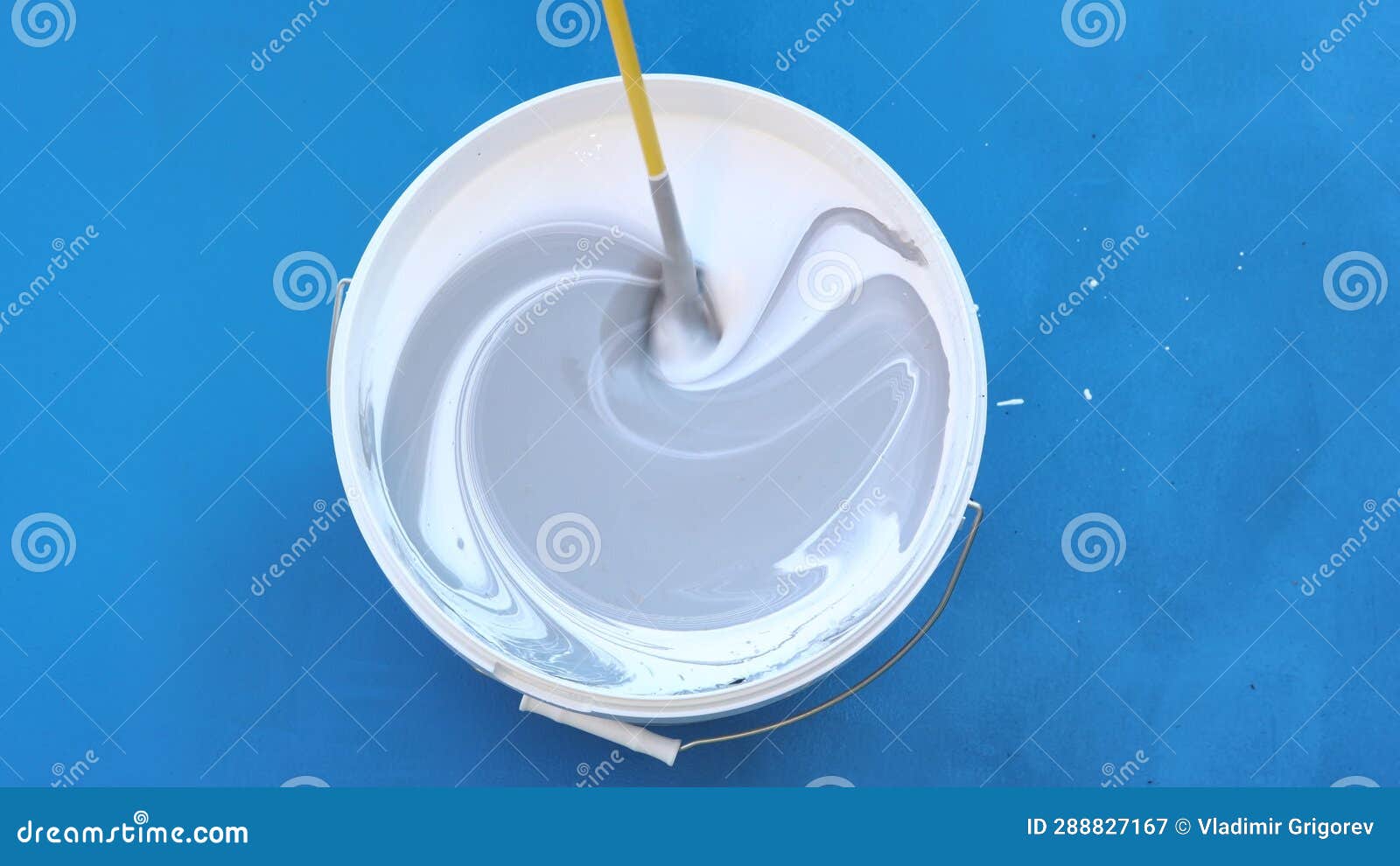 Three Colors of Paint are Mixed in Bucket of Paint with Mixer. Stock ...